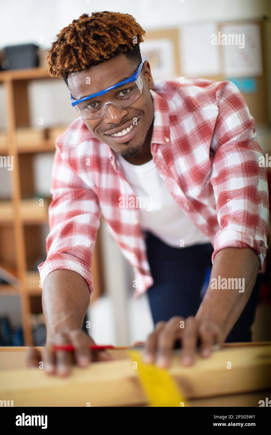 local african carpenter at work smiling Stock Photo - Alamy