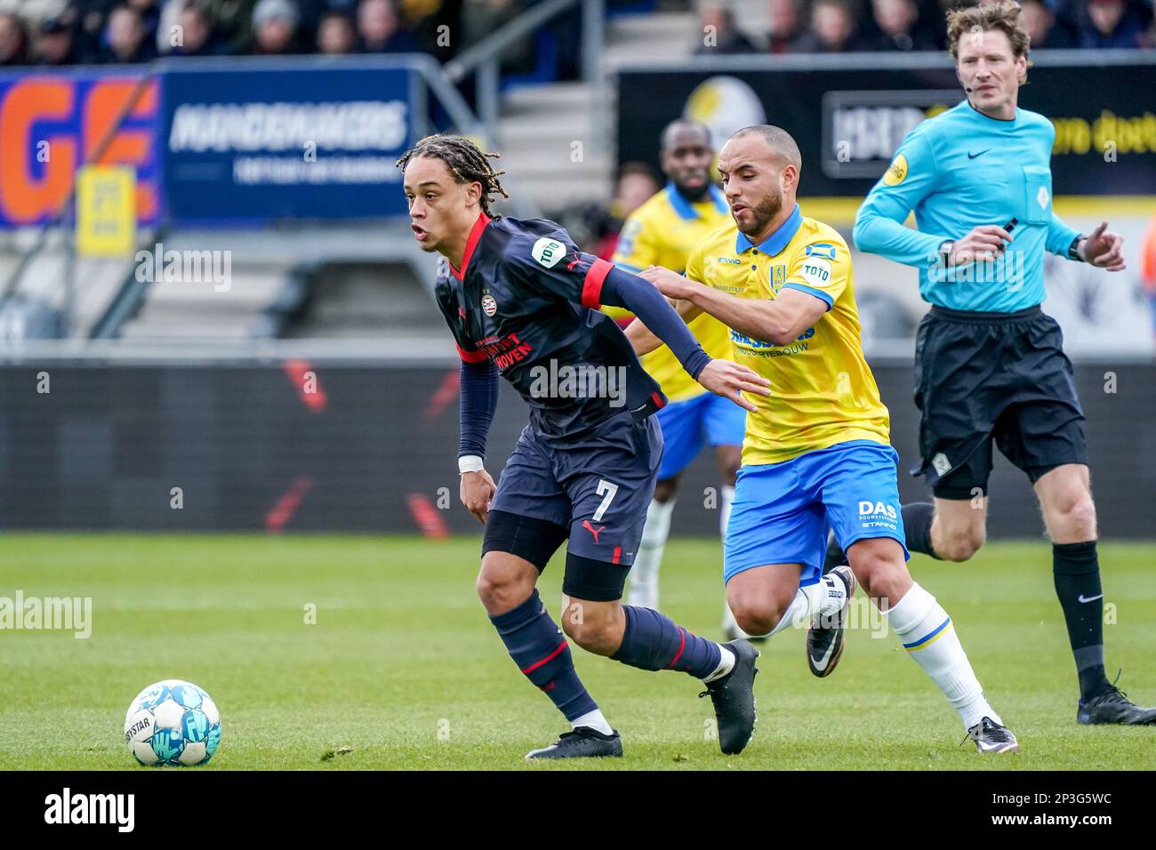 WAALWIJK, NETHERLANDS - MARCH 5: Xavi Simons of PSV runs with the ball after him Iliass Bel ...