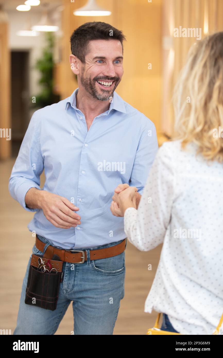 barber shaking hands with female customer Stock Photo - Alamy