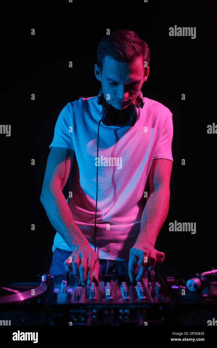 Cool club DJ mixing records on party. Professional disc jockey playing ...