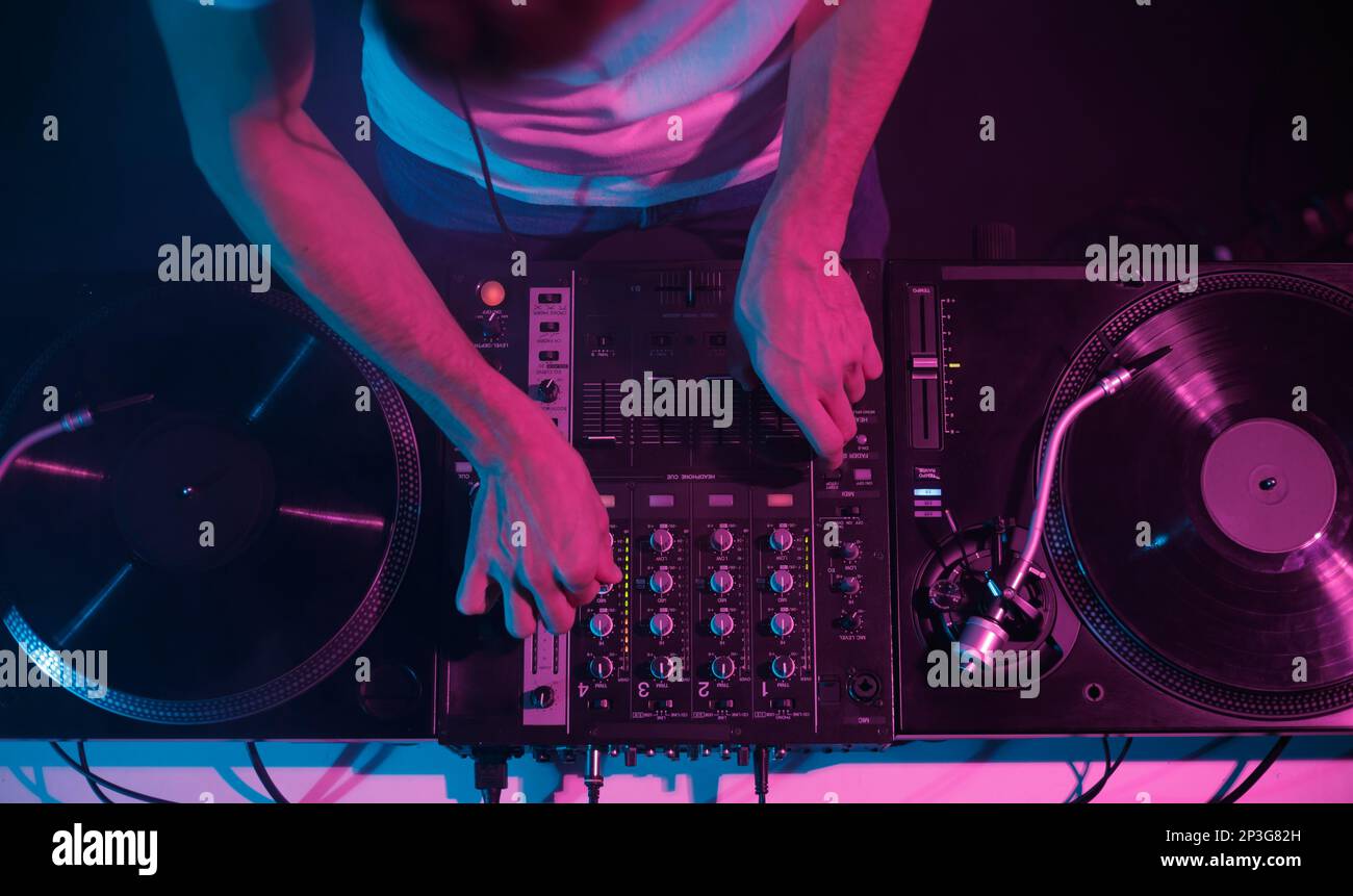 Overhead photo of disc jockey mixing records on party in night club ...