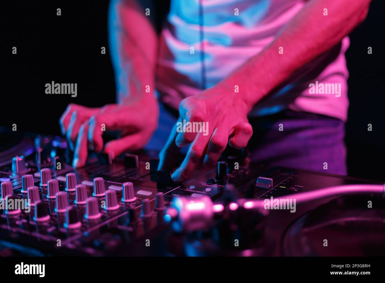 DJ playing music on party in night club. Close up photo of professional ...