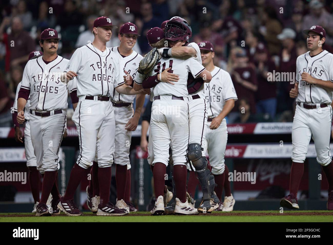 Texas A&M Aggies relief pitcher Josh Stewart (34) gets a hug from ...