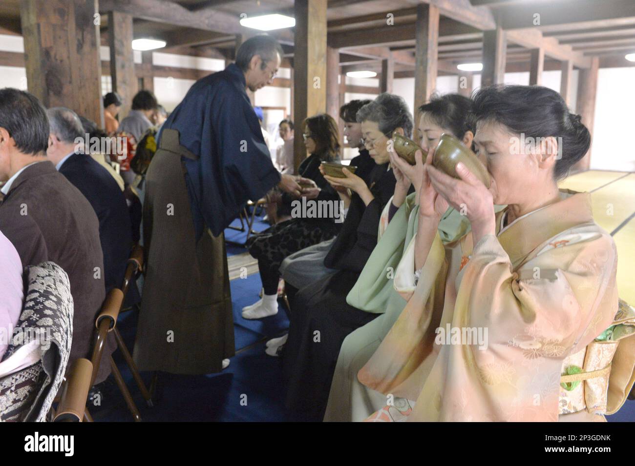 Visitors enjoy drinking a cup of tea at the Gokurakudo main hall of the ...