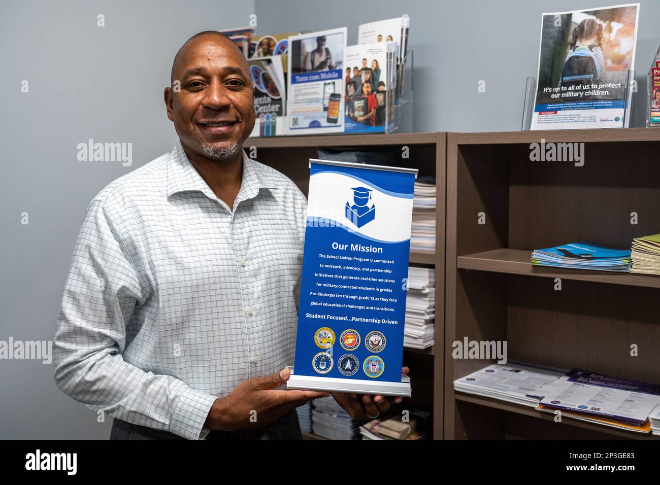 Darren Hill, 23rd Force Support Squadron school liaison, holds the ...