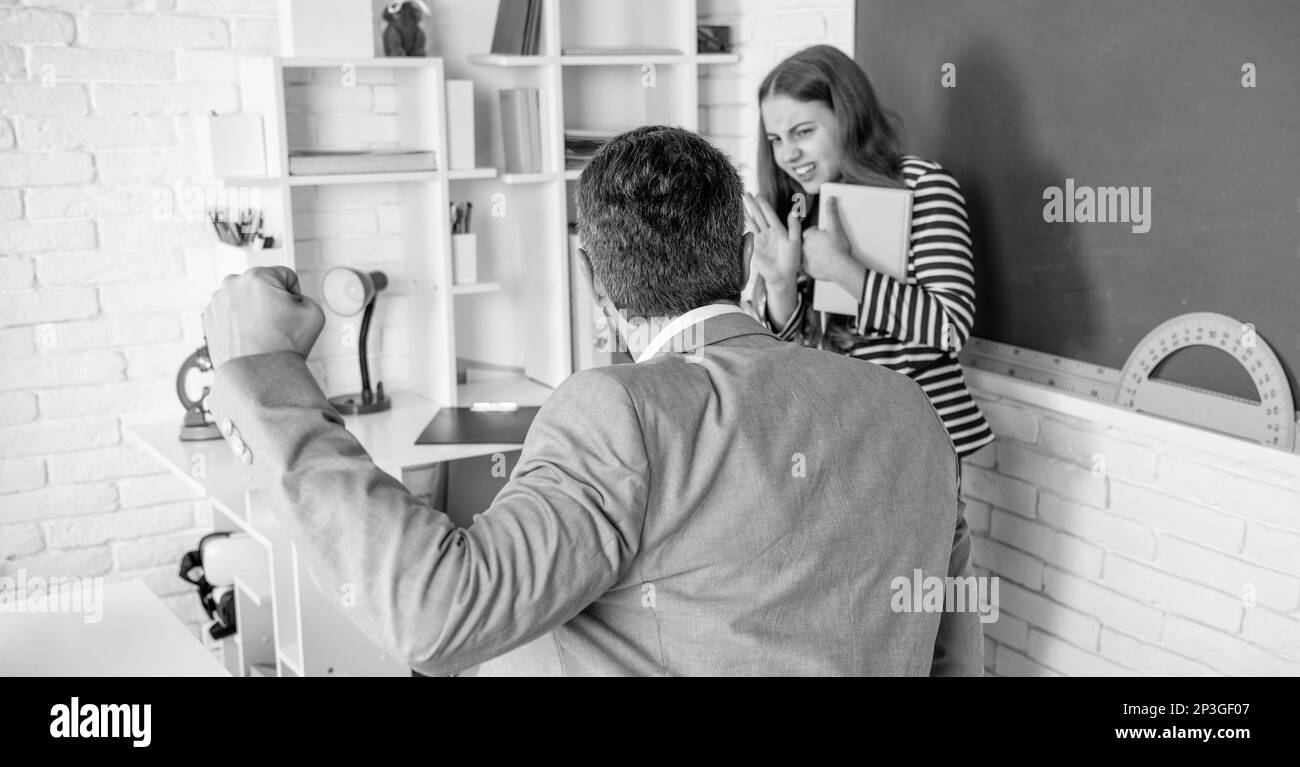 aggressive teacher shouting at child at blackboard Stock Photo - Alamy
