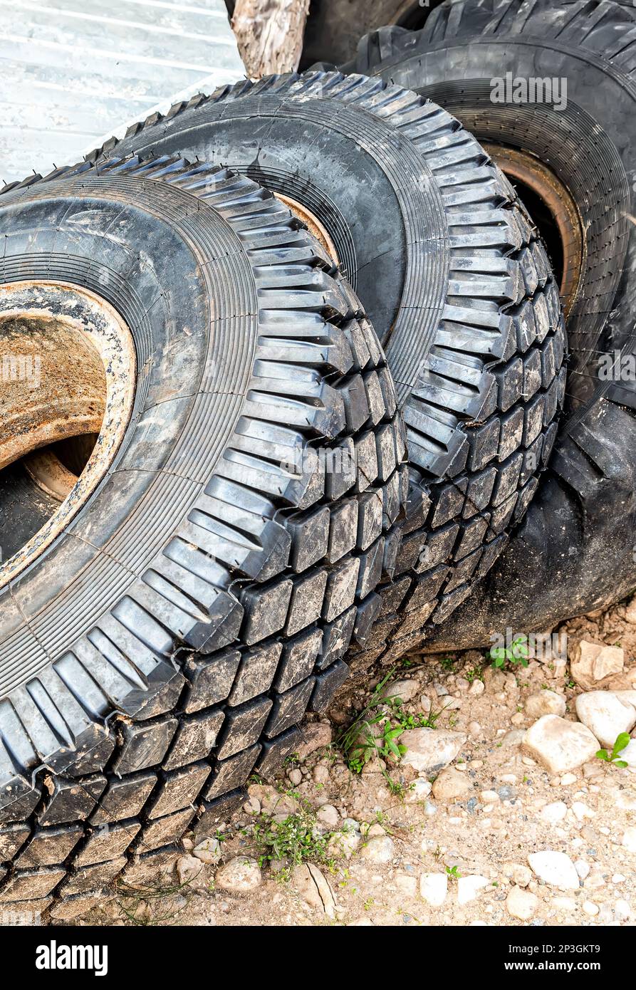 Old and used up truck tires covered in dust and rust outdoors. Disposal ...