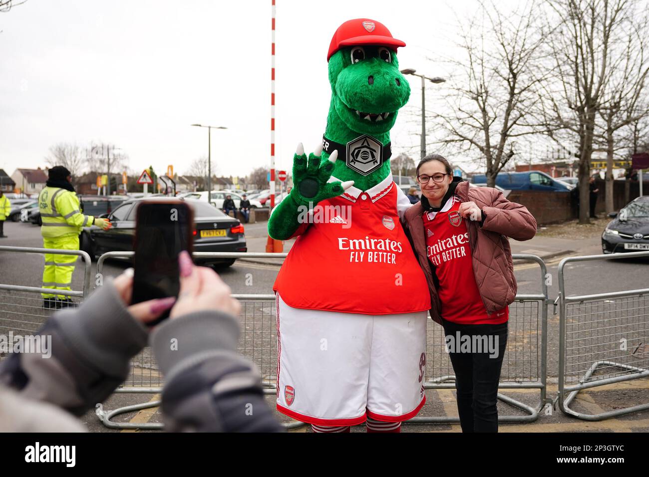 Gunnersaurus, the Arsenal mascot, meets with fans outside the stadium ...
