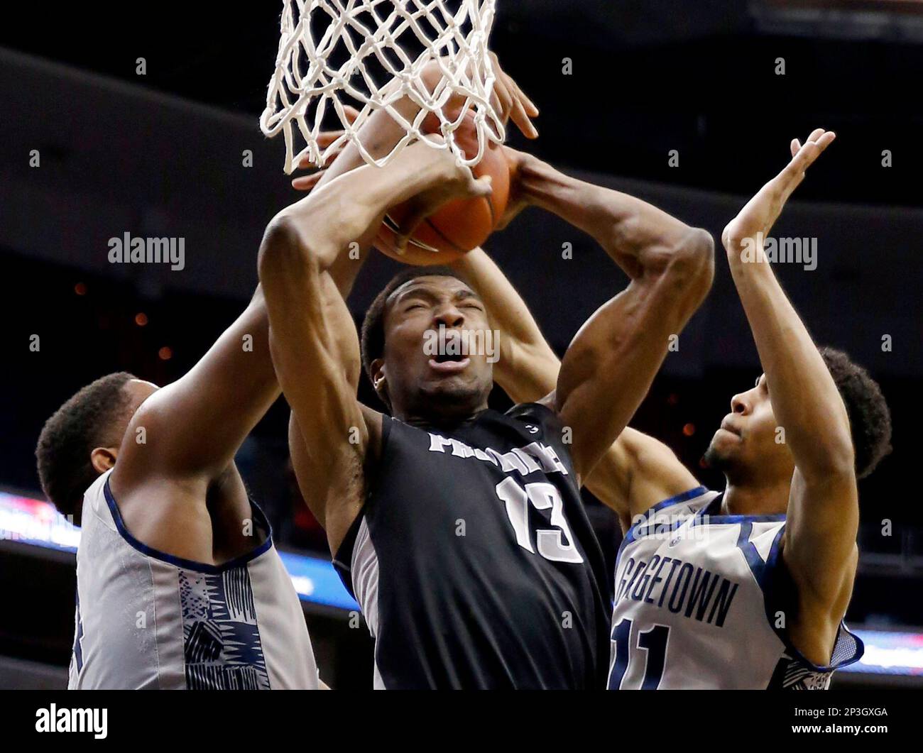 Providence center Paschal Chukwu (13) attempts to shoot between ...