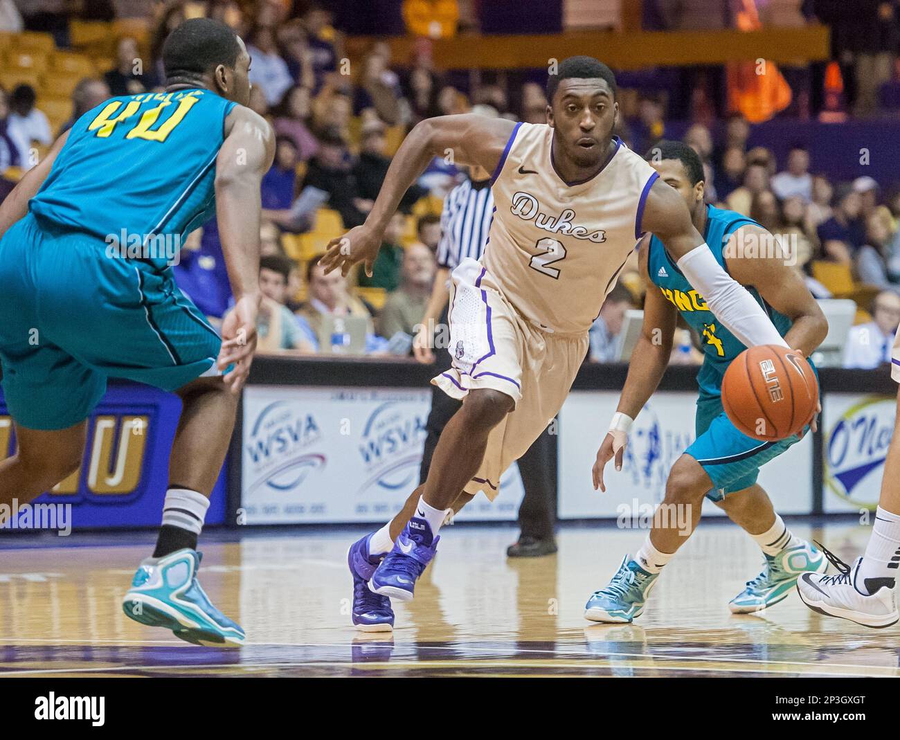 James Madison guard Ron Curry (2) drives through a hole in UNC ...