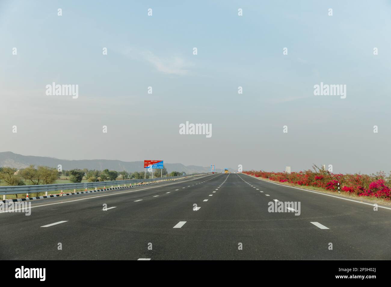 The highway bordered by lush greenery and mountains, India's Delhi ...