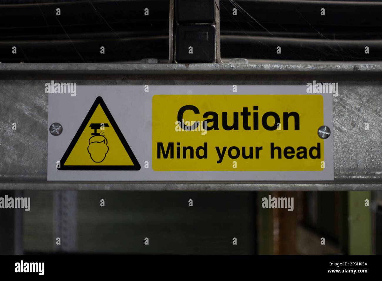 Caution Mind Your Head Sign fixed to a steel girder Stock Photo - Alamy