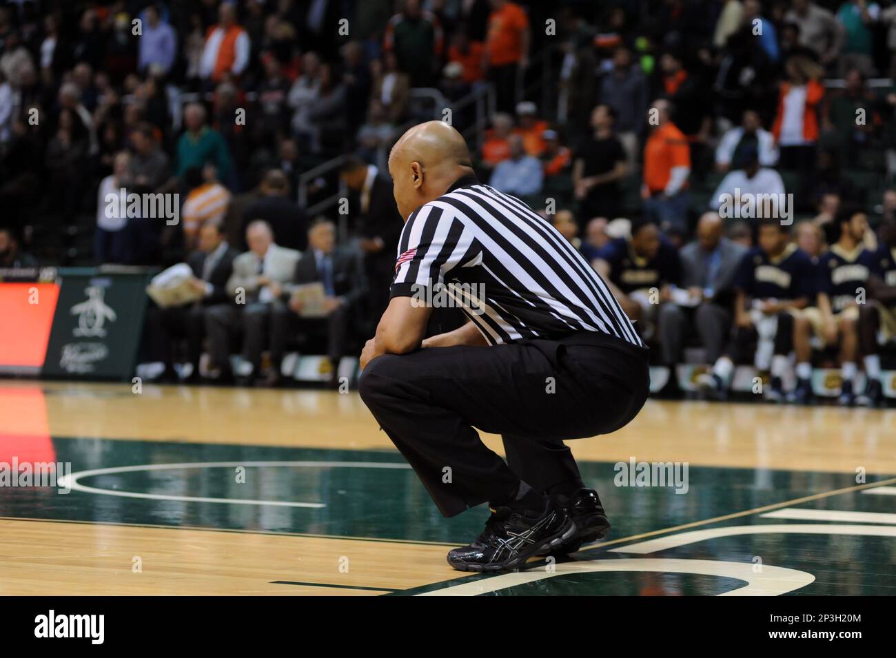 An NCAA referee surveys the court before the Miami Hurricanes play ...