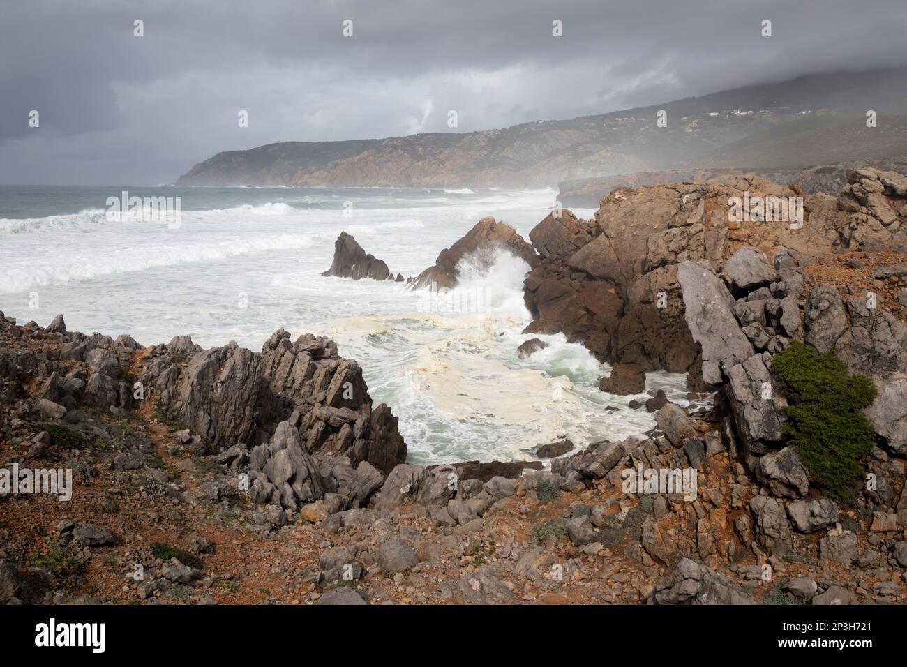 Stormy Atlantic Ocean waves crashing onto rocks below Forte do Guincho ...
