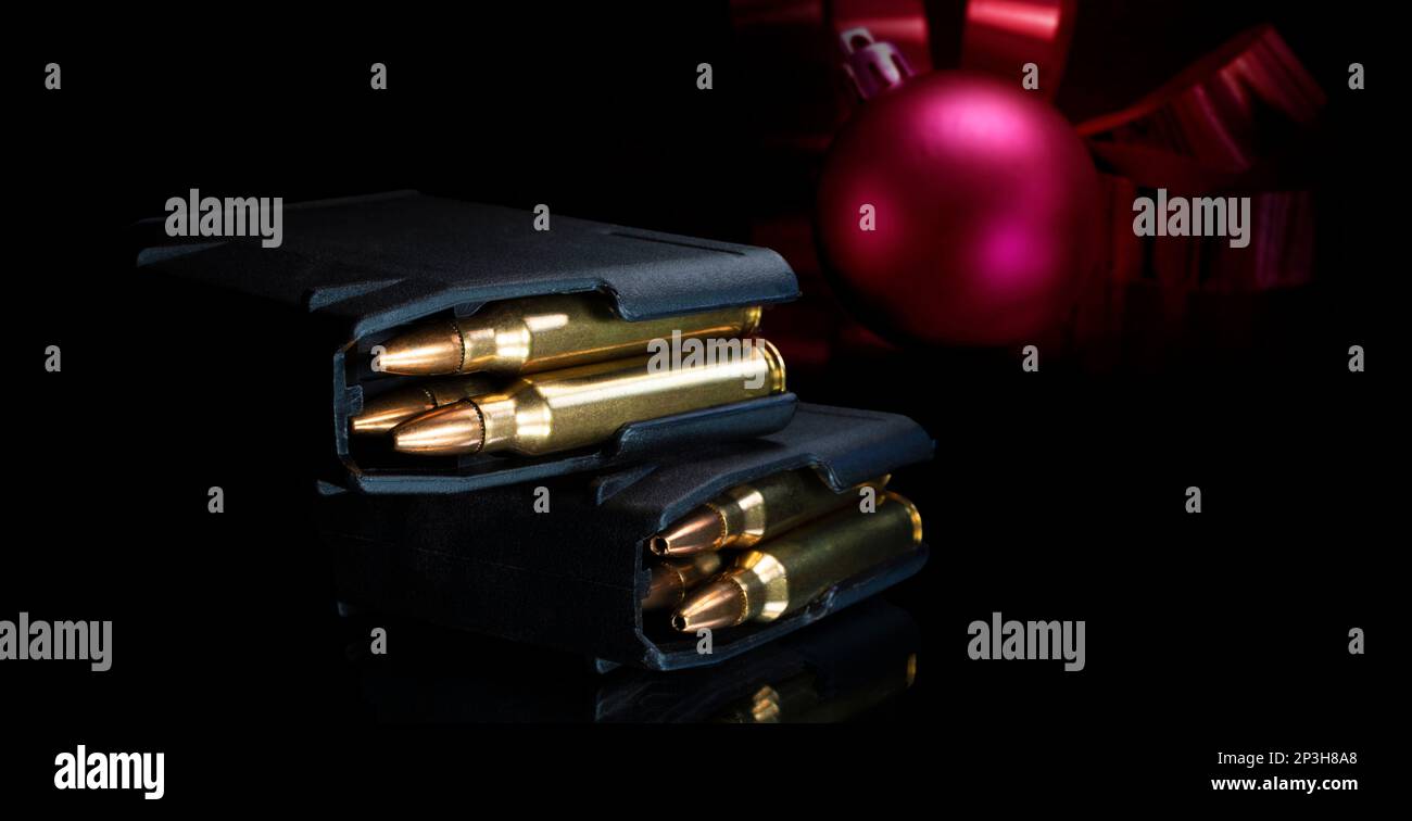 Two loaded magazines with a Christmas ornament behind Stock Photo - Alamy