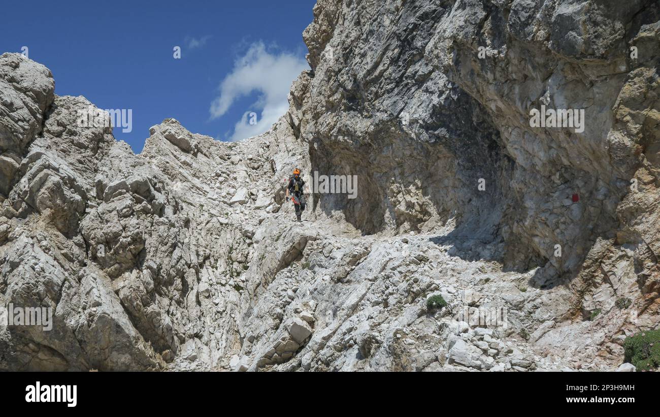 Tourist with equipment on the via ferrata trail in the Dolomites ...
