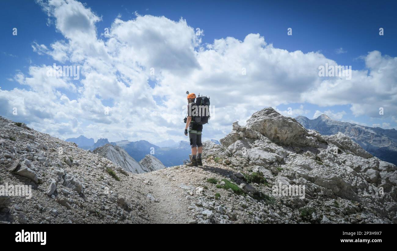 Tourist with equipment on the via ferrata trail in the Dolomites ...
