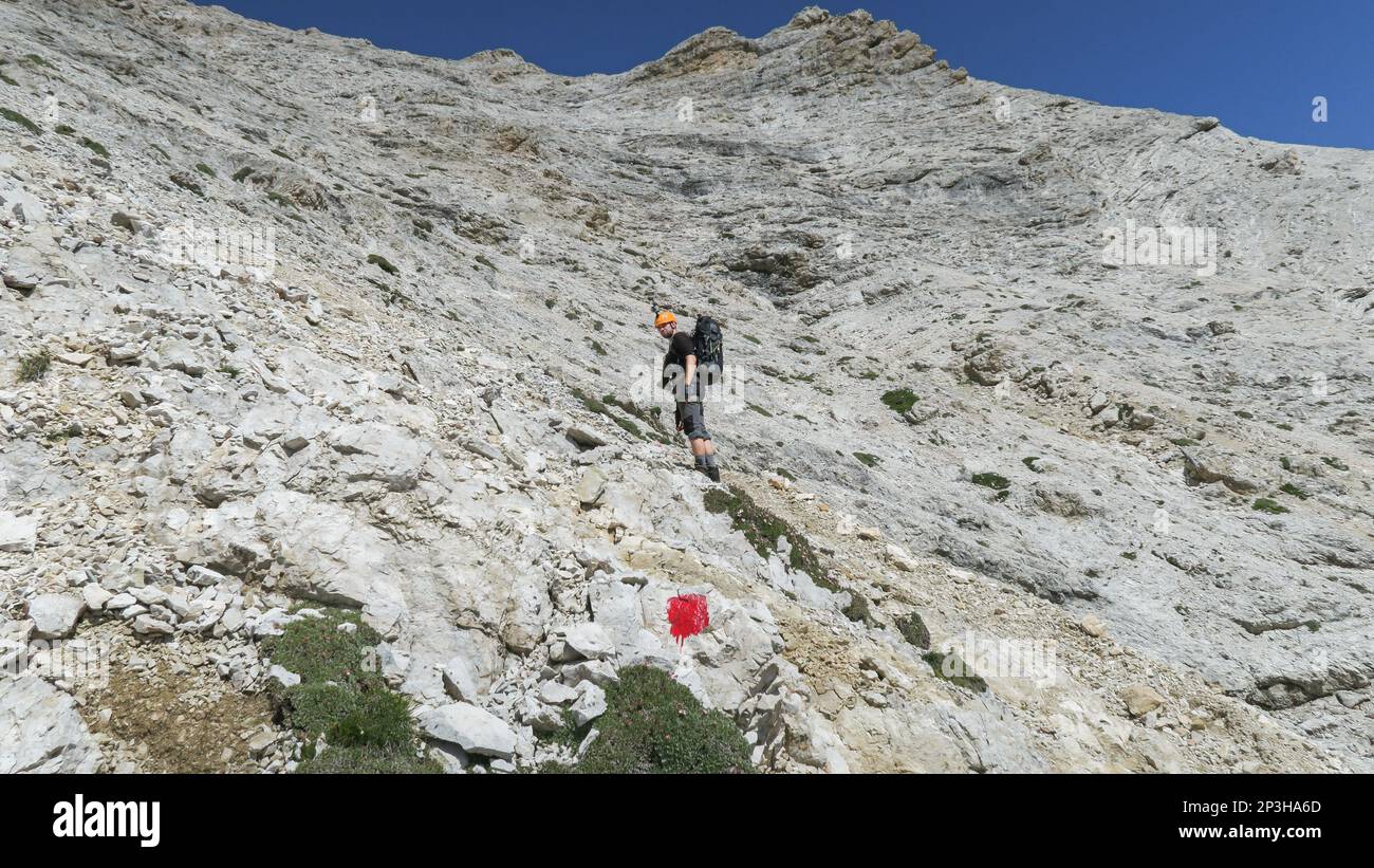 Tourist with equipment on the via ferrata trail in the Dolomites ...