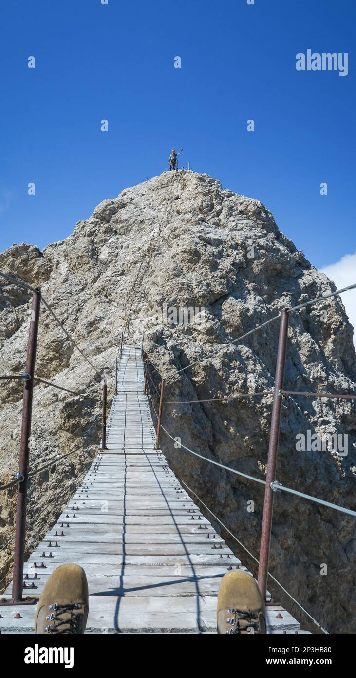 Tourist on the suspension bridge in Monte Cristallo, Dolomite Alps ...