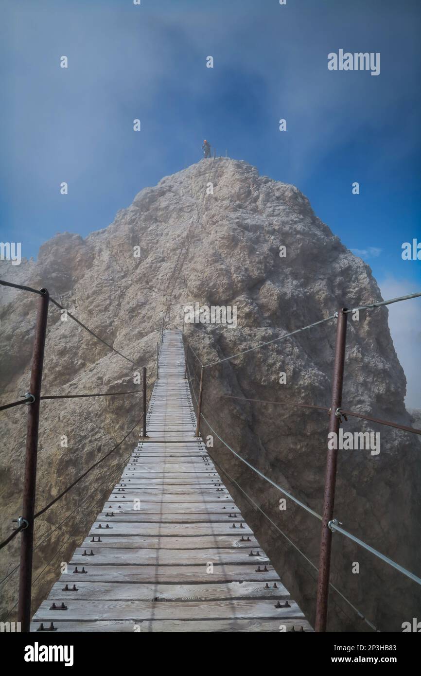 Tourist on the suspension bridge in Monte Cristallo, Dolomite Alps ...