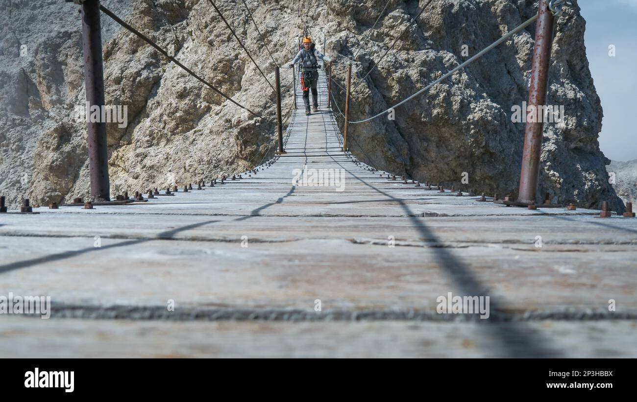 Tourist on the suspension bridge in Monte Cristallo, Dolomite Alps ...