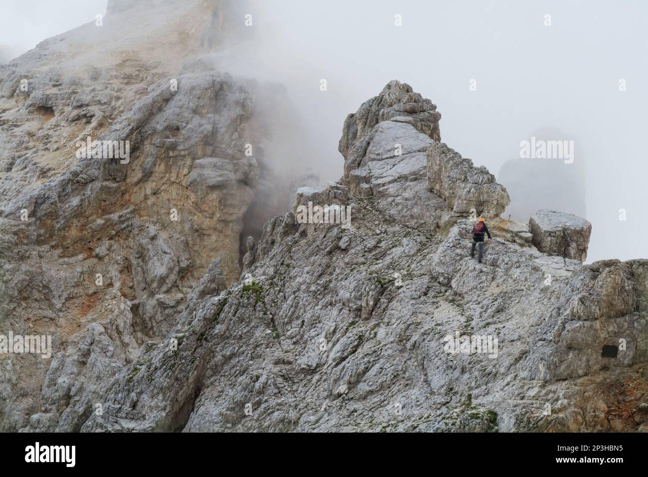 Tourist with equipment on the via ferrata trail in the alps. Dolomites ...
