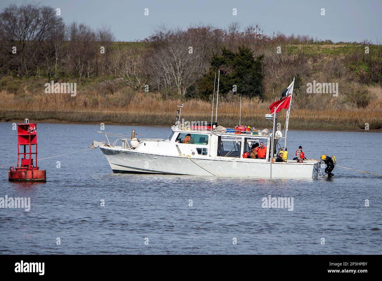 In this photo provided by the Georgia Port Authority, divers prepare to ...
