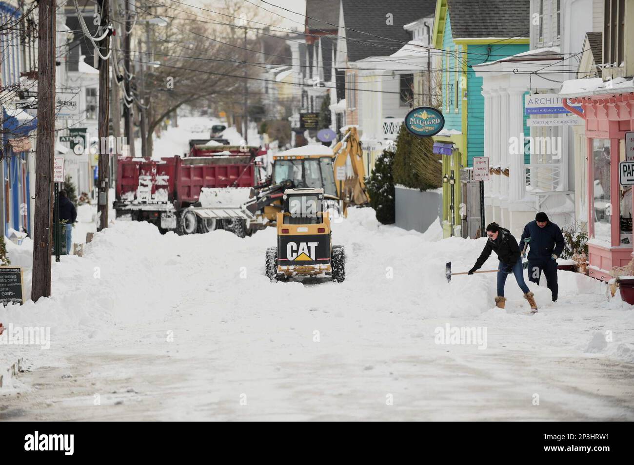 Megan Coon shovels snow from a sidewalk after a winter storm, Wednesday ...