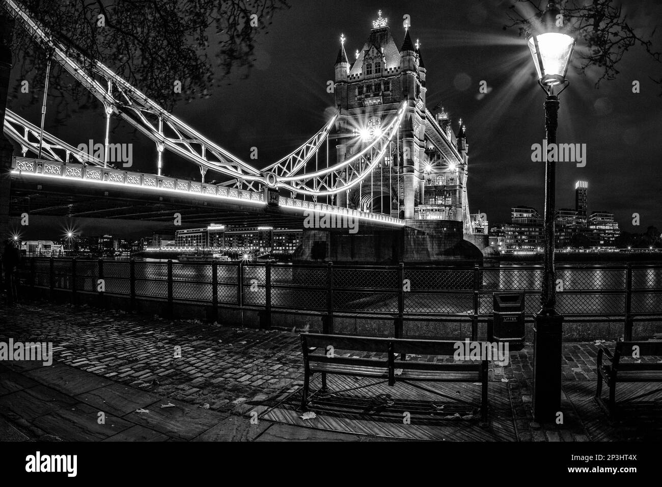 A stunning greyscale shot of London's iconic Tower Bridge at night ...