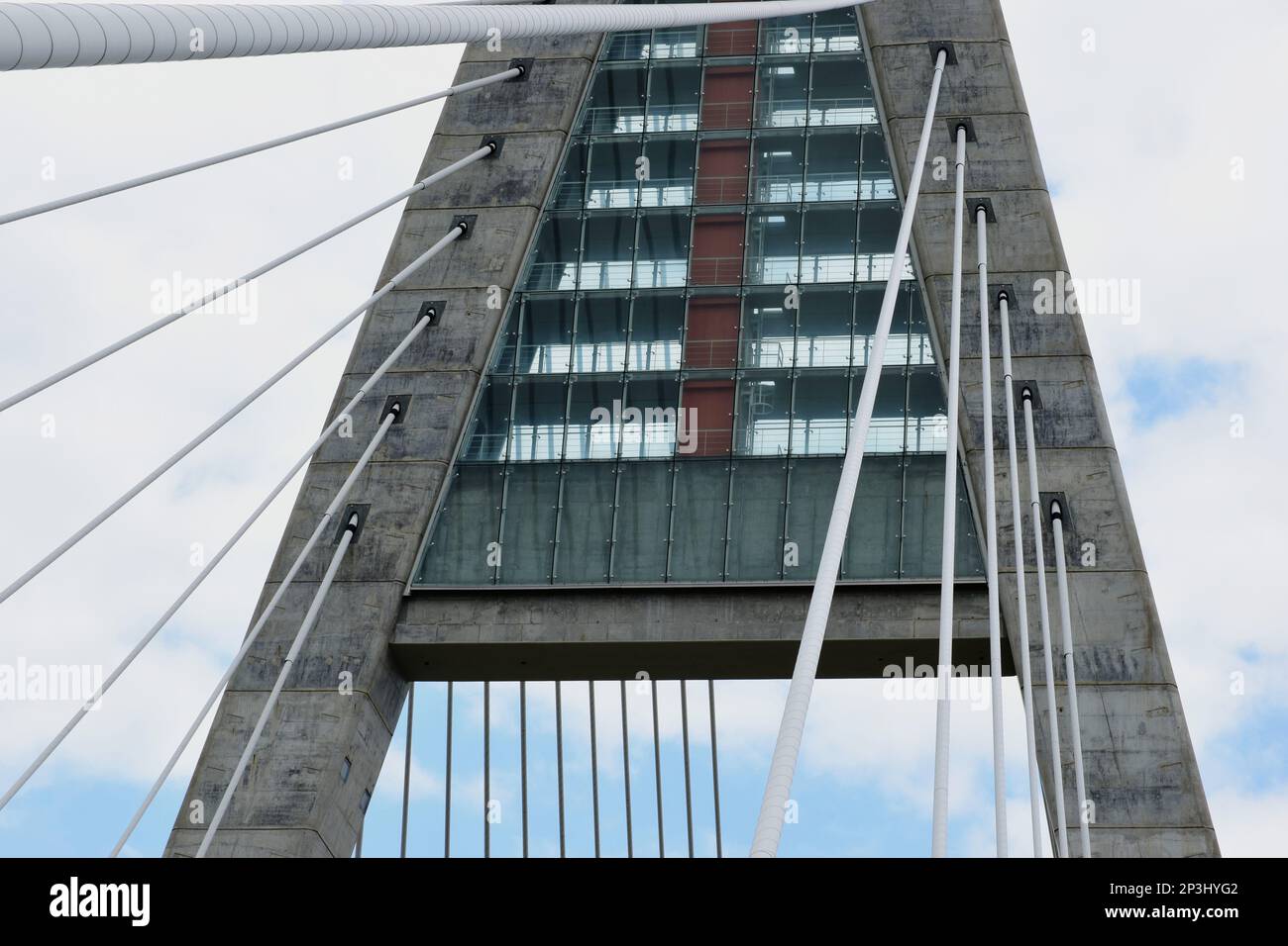 Suspension bridge concrete tower frame detail with heavy white steel ...