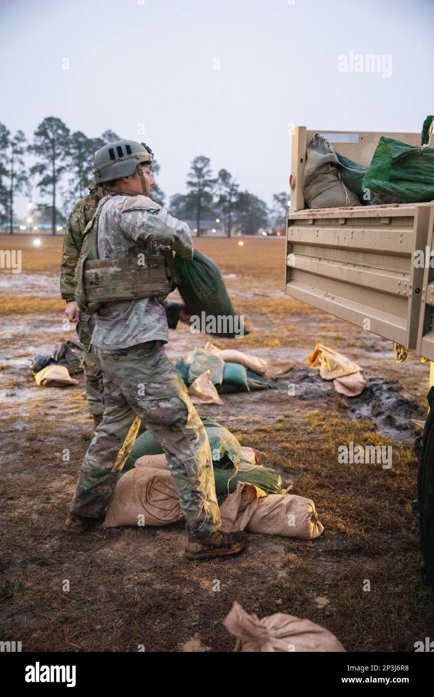 A soldier assigned to the 3rd Infantry Division loads 16 sandbags into ...