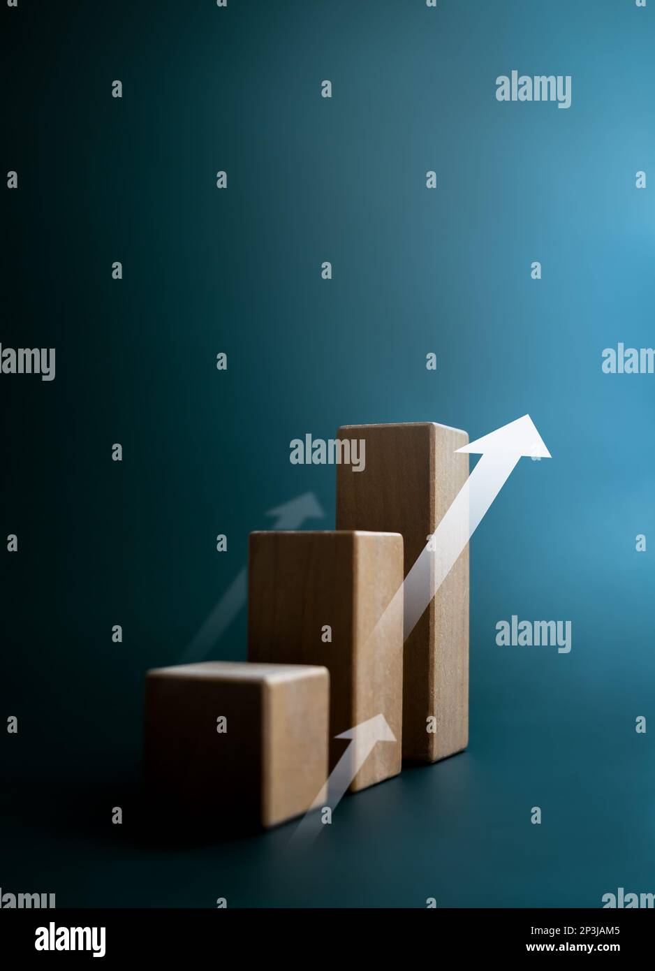 Rise up arrow on wooden cube blocks, bar graph chart steps on dark blue ...