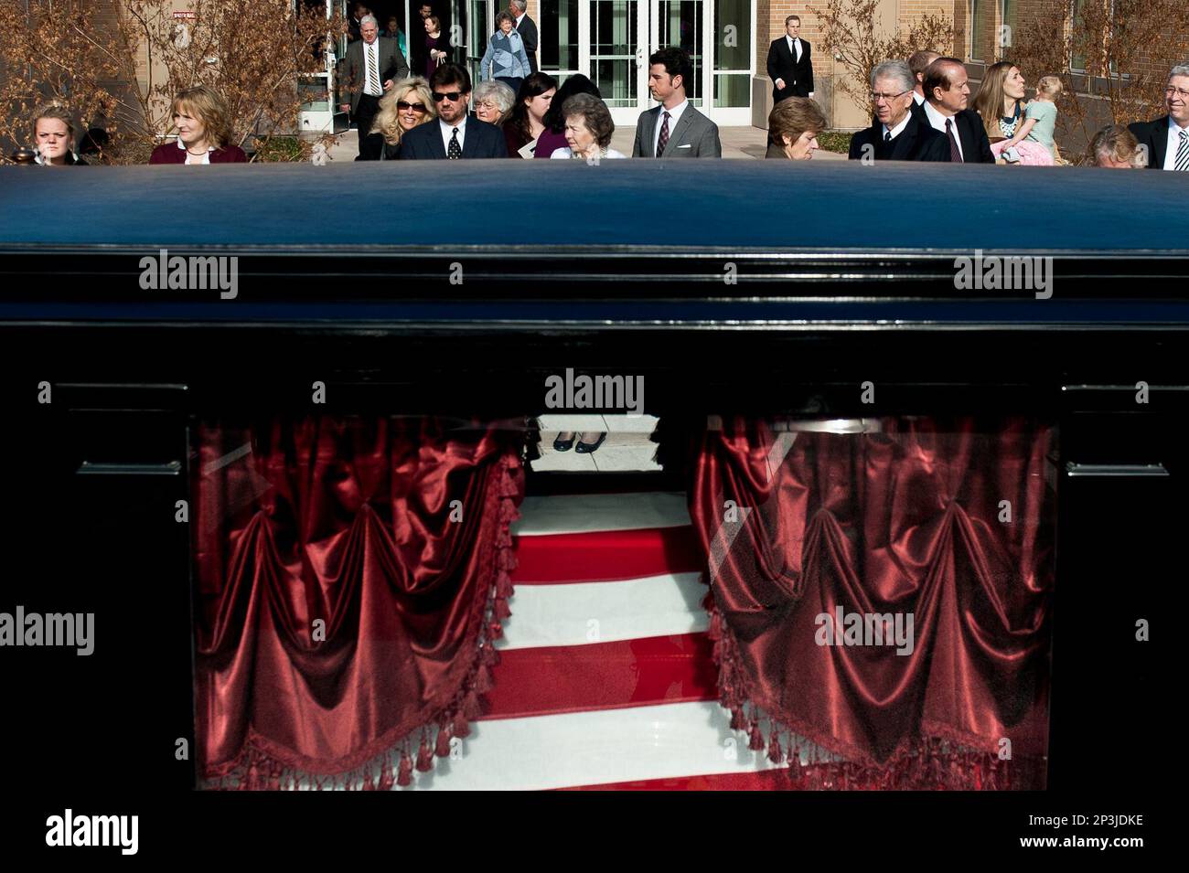 People gather around a horse-drawn hearse carrying former Speaker of ...