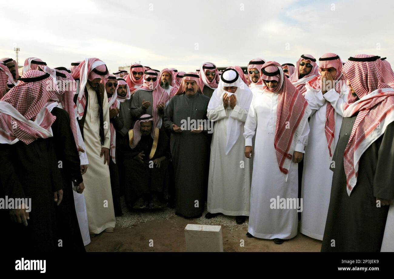 In this photo provided by the Saudi Press Agency, relatives of late ...