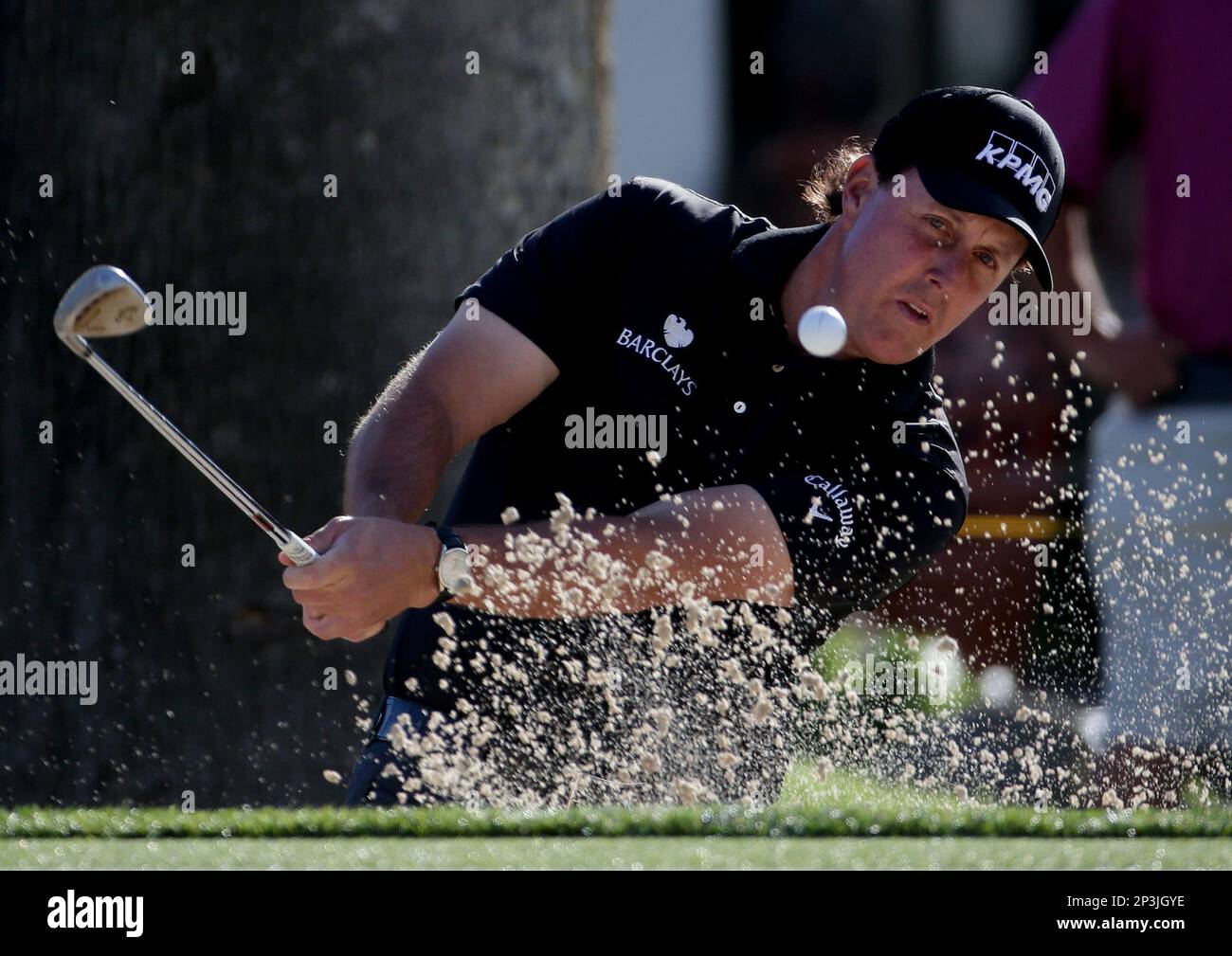 Phil Mickelson watches his bunker shot on the fourth hole during the ...