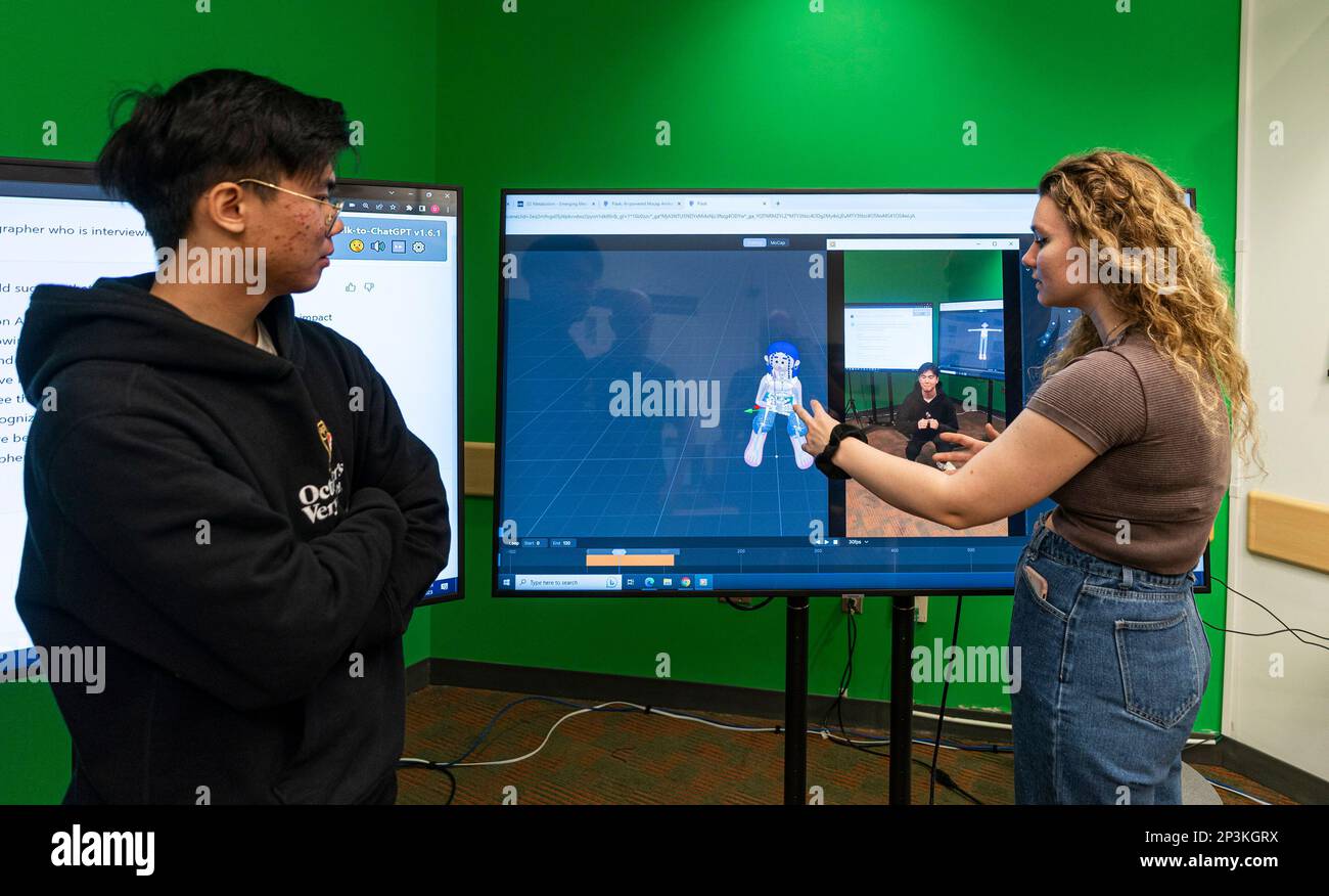 Student Olivia How (right) discusses the AI assisted animation of Jerry ...
