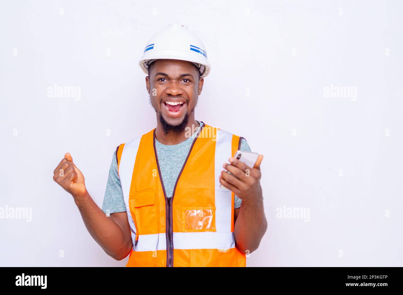 excited smart engineer excited as he uses his cell isolated over white ...
