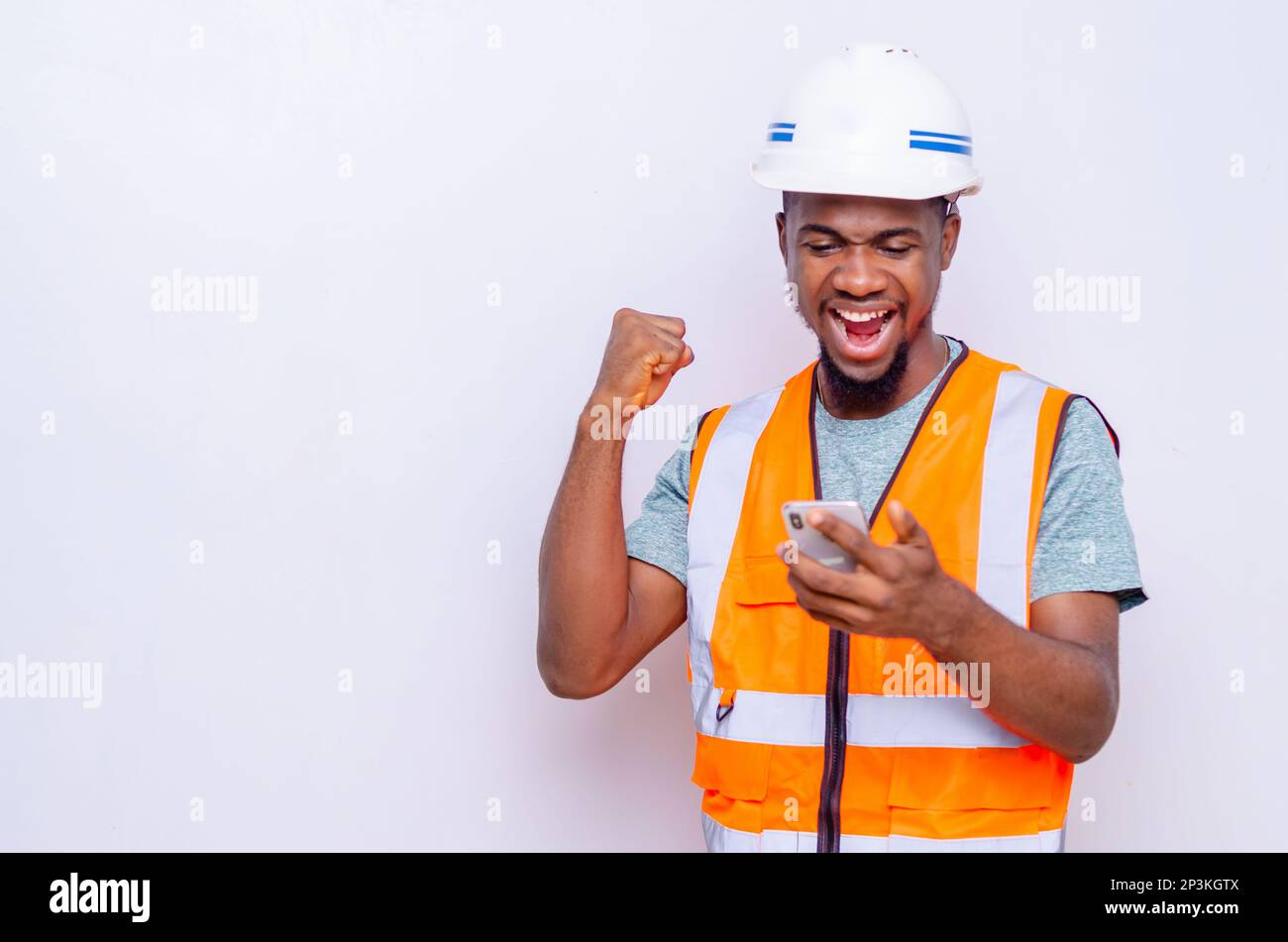 excited smart engineer excited as he uses his cell isolated over white ...
