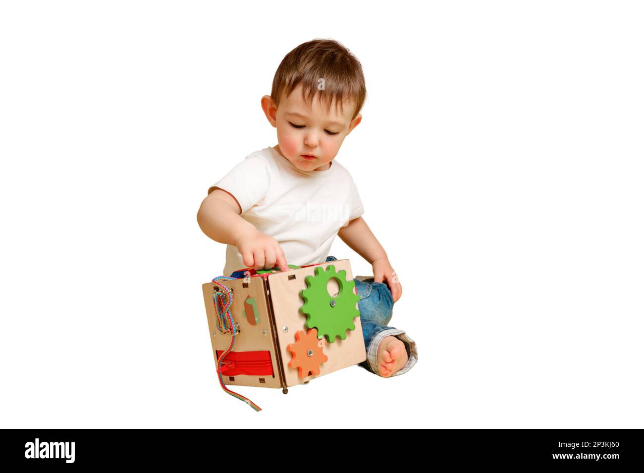 Toddler baby is playing logic educational games busyboard on a studio ...
