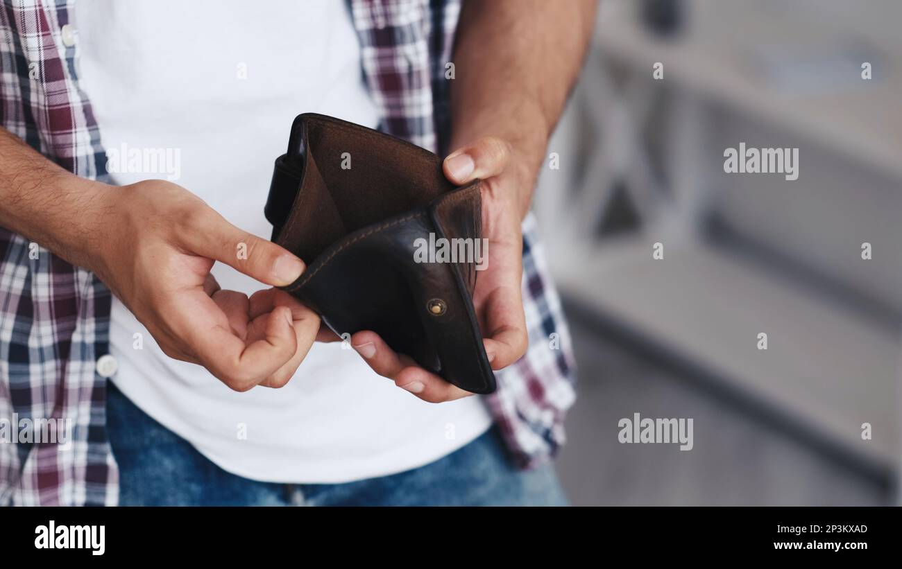No money poverty problem man hands empty wallet Stock Photo - Alamy