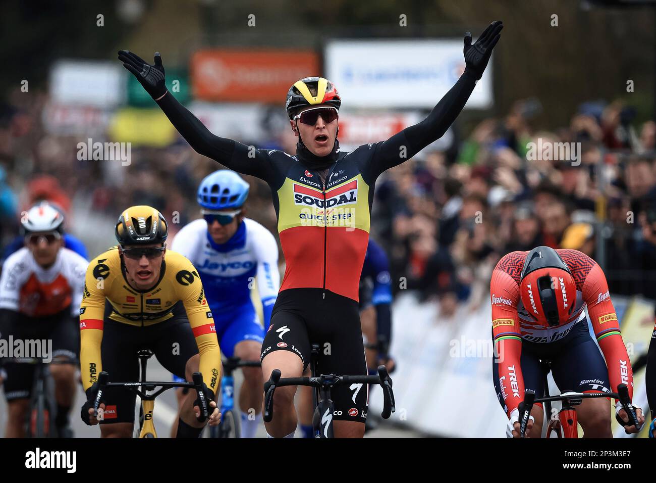 Soudal Quick-Step's Belgian rider Tim Merlier, center, crosses the ...