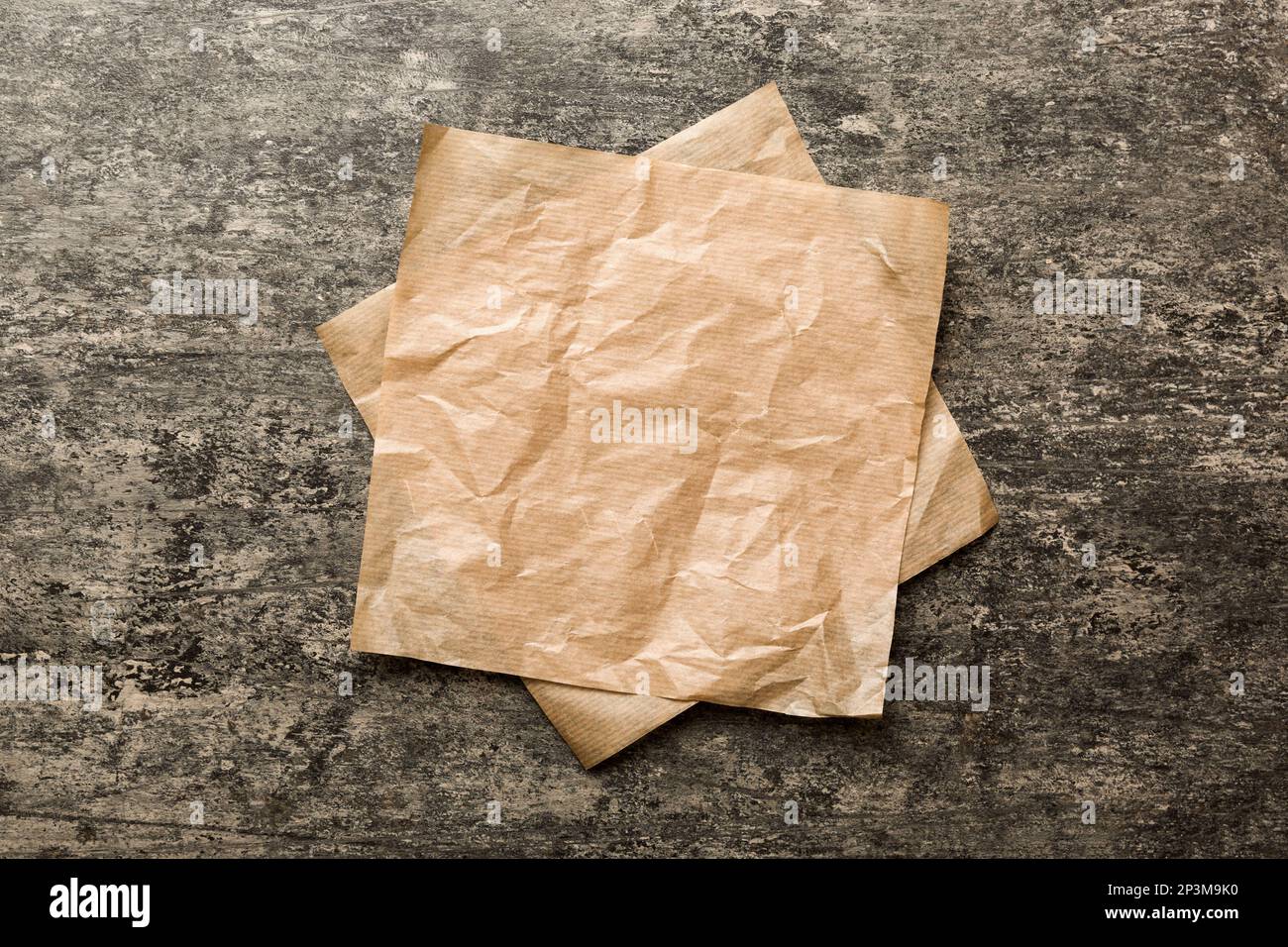 top view with baking parchment empty on table background. Folded cloth ...