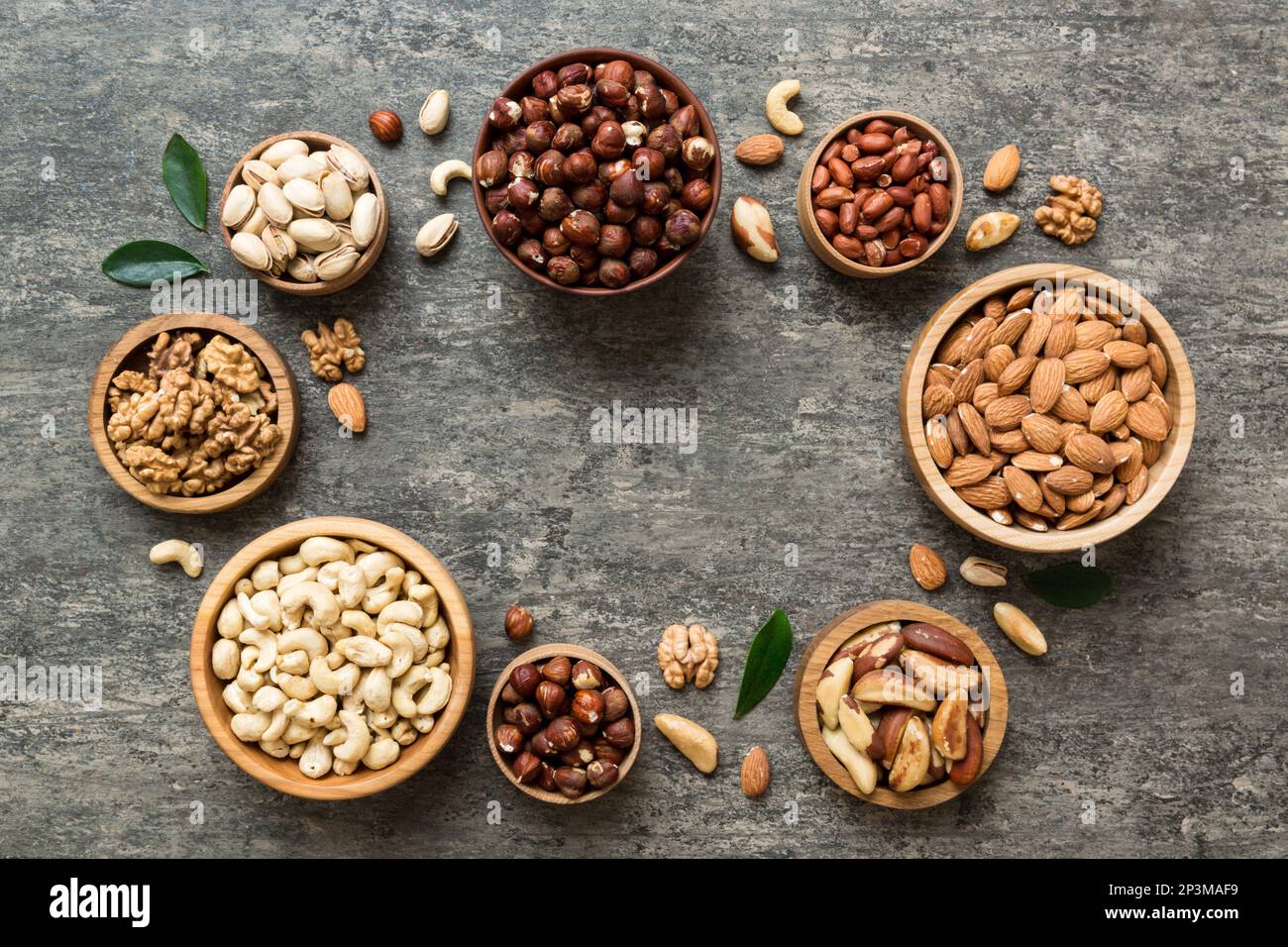 mixed nuts in wooden bowl. Mix of various nuts on colored background ...