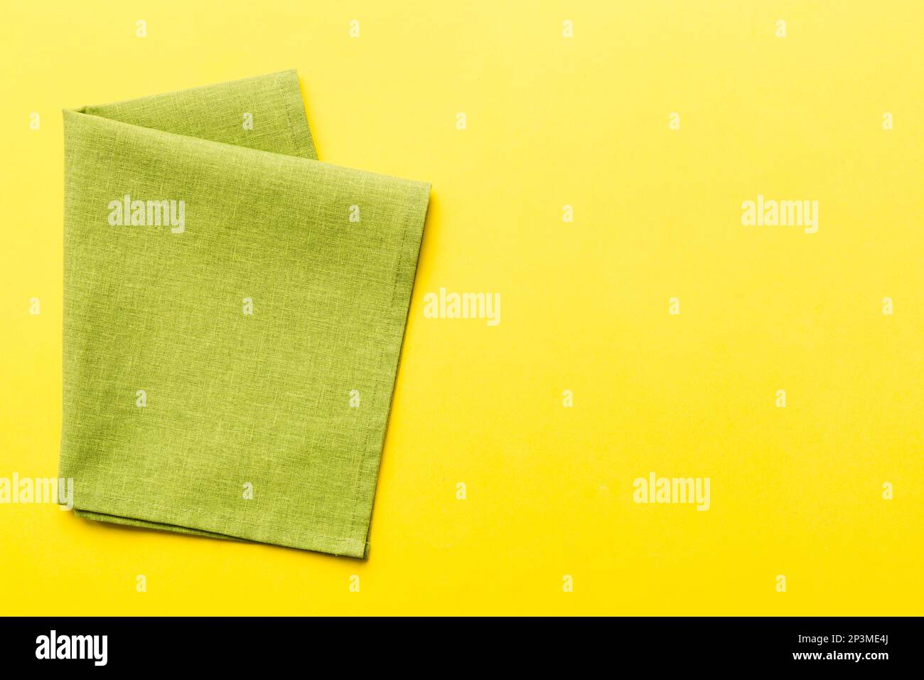 top view with green kitchen napkin isolated on table background. Folded ...