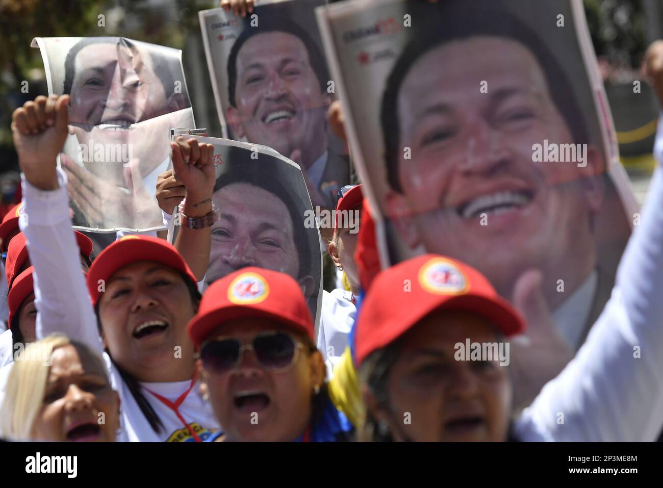 People hold posters with the image of late Venezuelan President Hugo ...