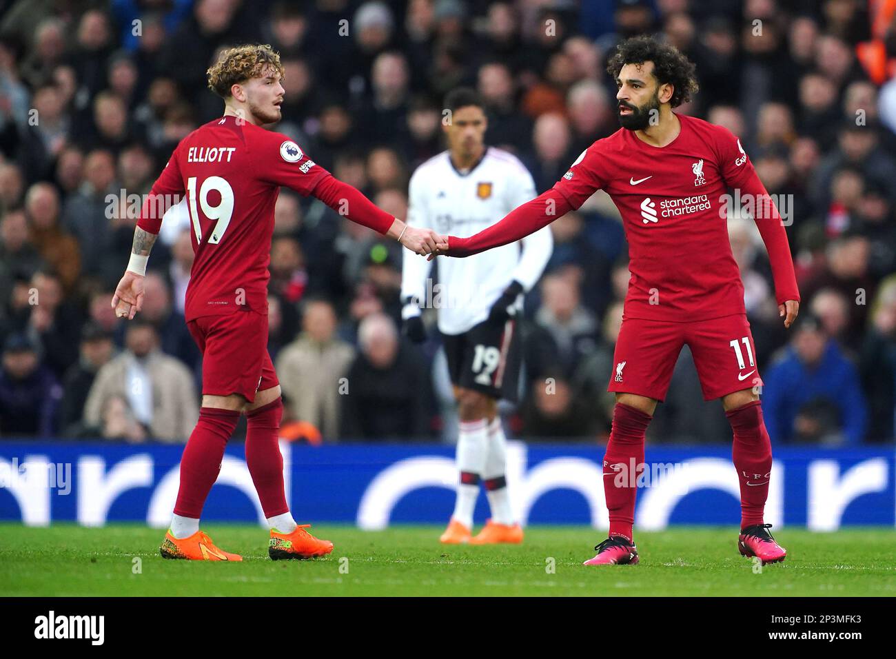 Liverpool's Mohamed Salah (right) and Liverpool's Harvey Elliott shake ...