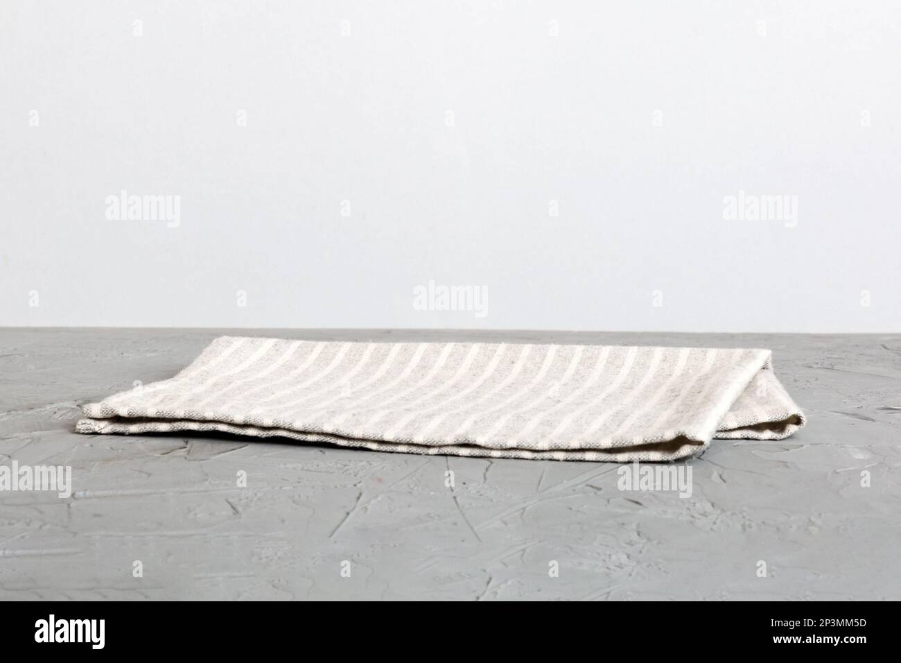 top view with gray kitchen napkin isolated on table background. Folded ...