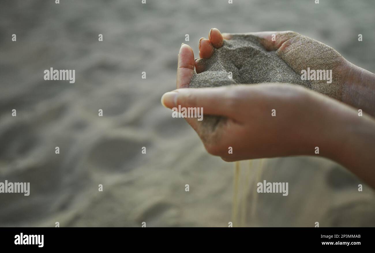 Sand slips through your fingers. Time is fleeting Stock Photo - Alamy