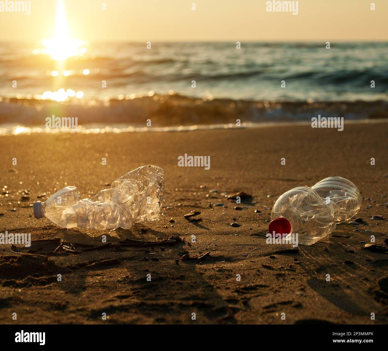 Plastic bottles on the sandy beach. Environmental pollution Stock Photo ...