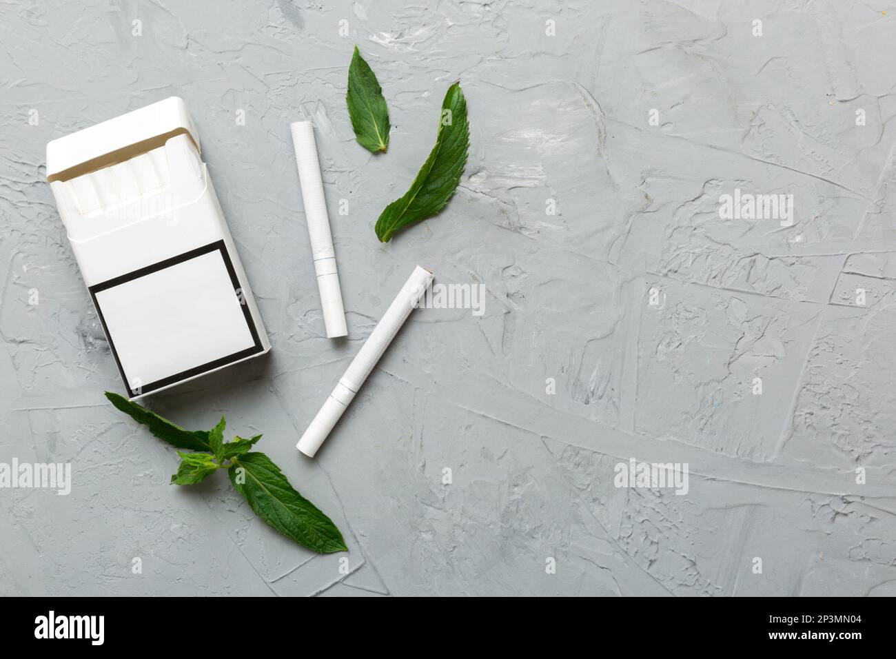 Pack of menthol cigarettes and fresh mint on colored table, Menthol ...